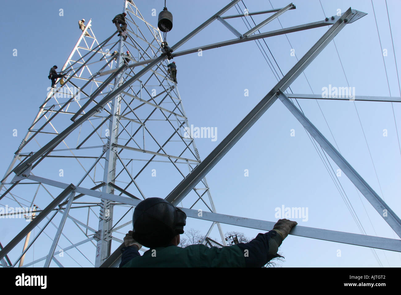 Chinese construction workers build power transmission pylon in ...