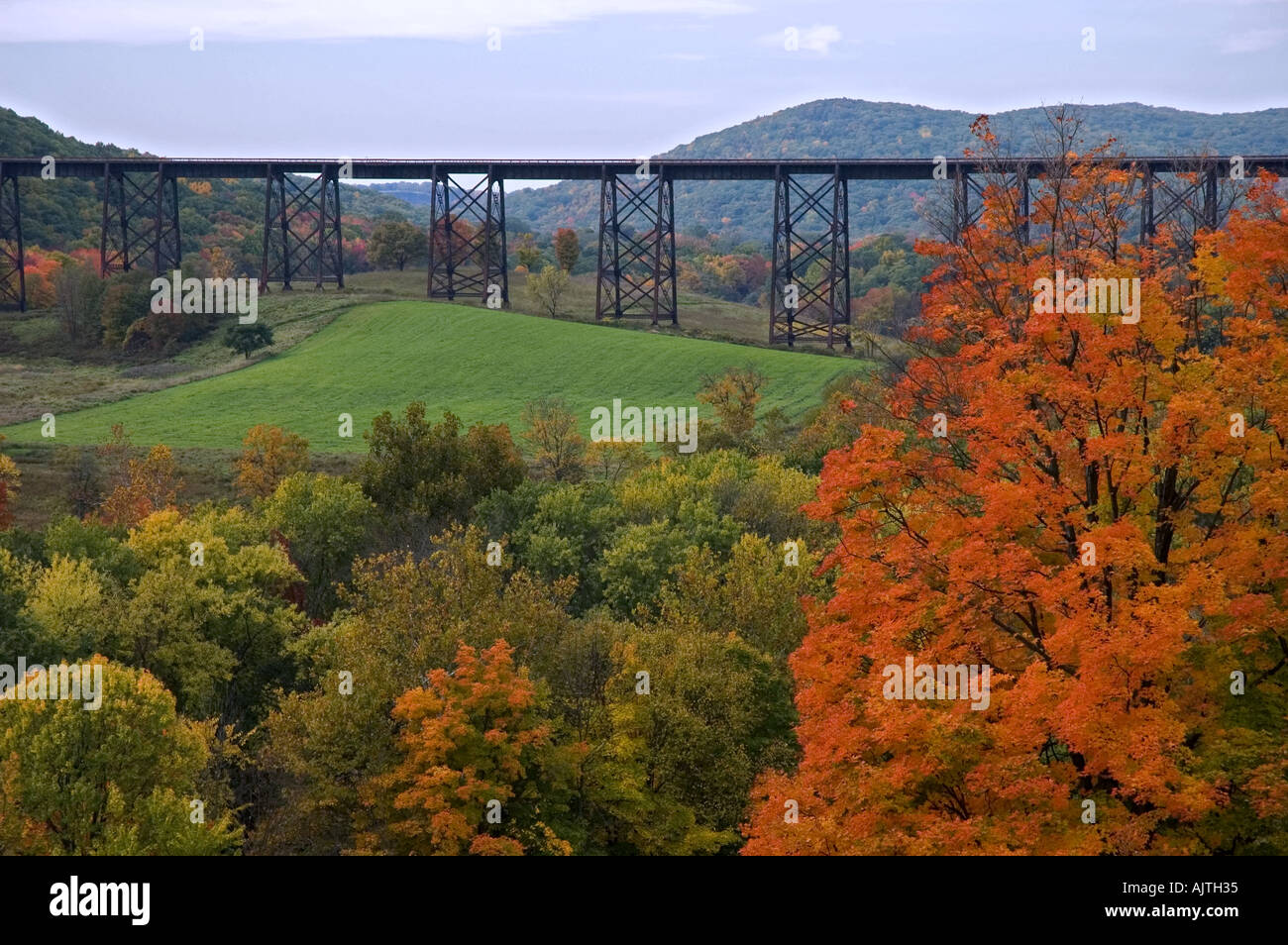 A train trestle bridge in autumn in Upper New York state USA set ...