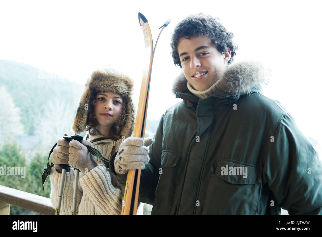 Teen brother and sister with ski gear, smiling at camera, portrait ...