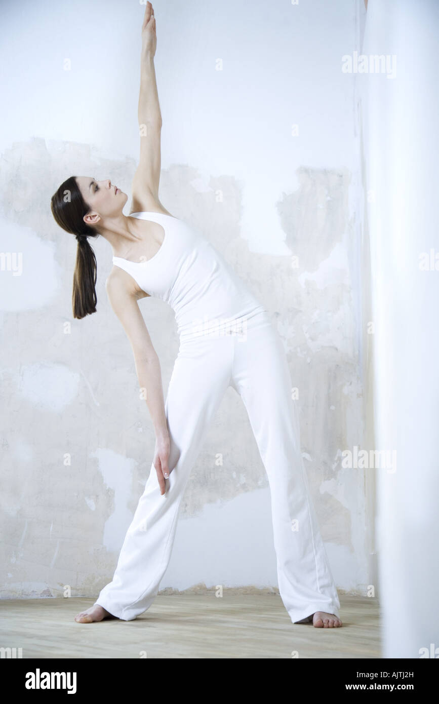 Woman standing, doing yoga pose, full length Stock Photo - Alamy