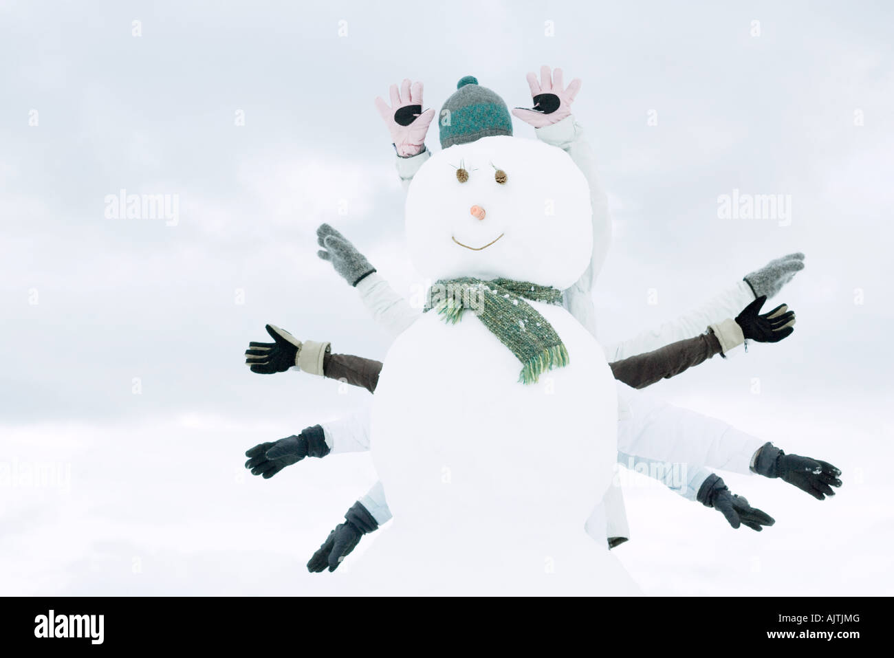 Snowman, several people's arms emerging from behind Stock Photo - Alamy