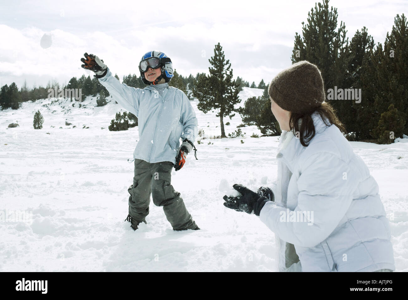 Young friends having snowball fight, action shot Stock Photo - Alamy