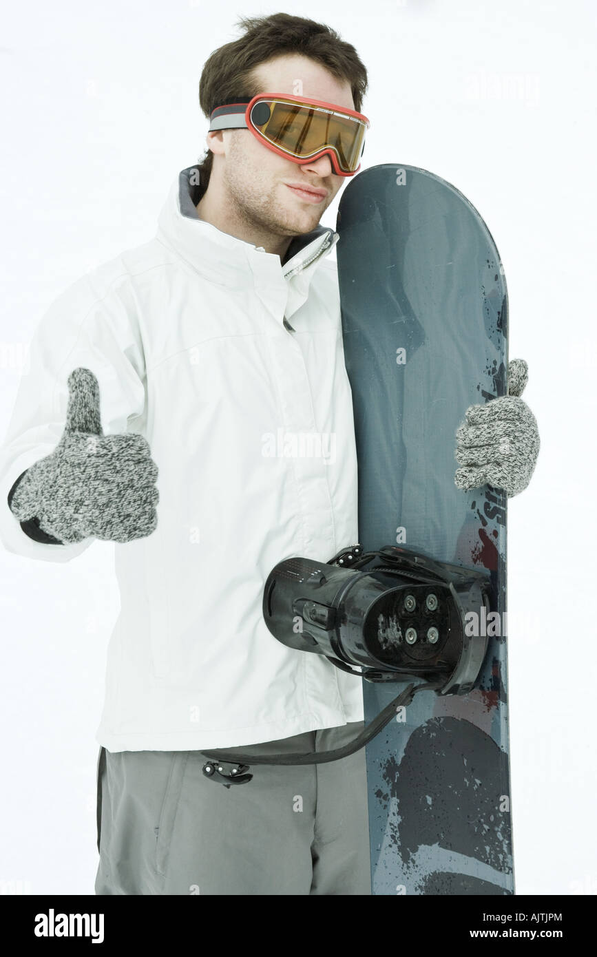 Young male snowboarder, giving thumbs up sign to camera Stock Photo - Alamy