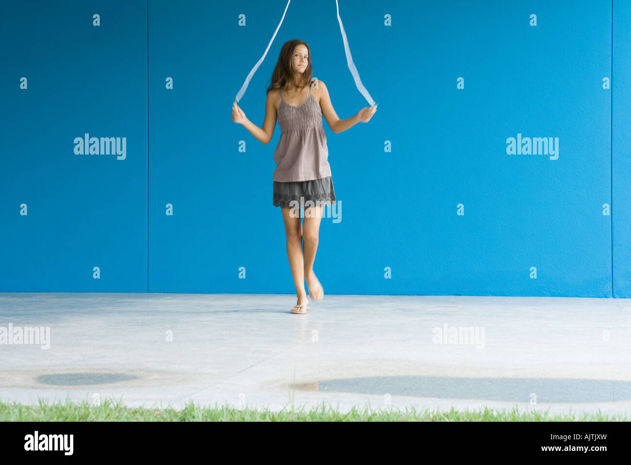 Young woman jumping rope, front view, full length Stock Photo - Alamy