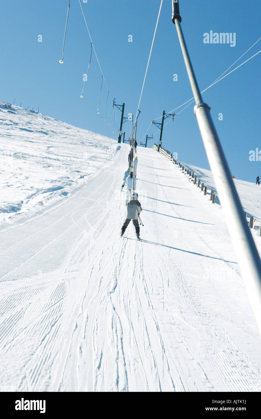 Young skiers using ski lift on ski slope, low angle view Stock Photo ...