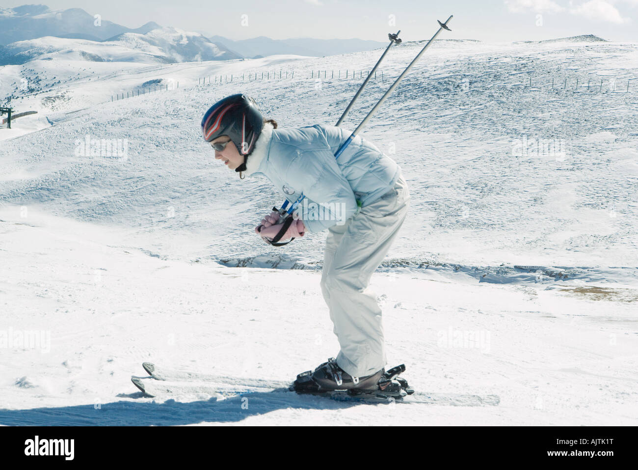 Young skier bending over, side view, full length portrait Stock Photo ...