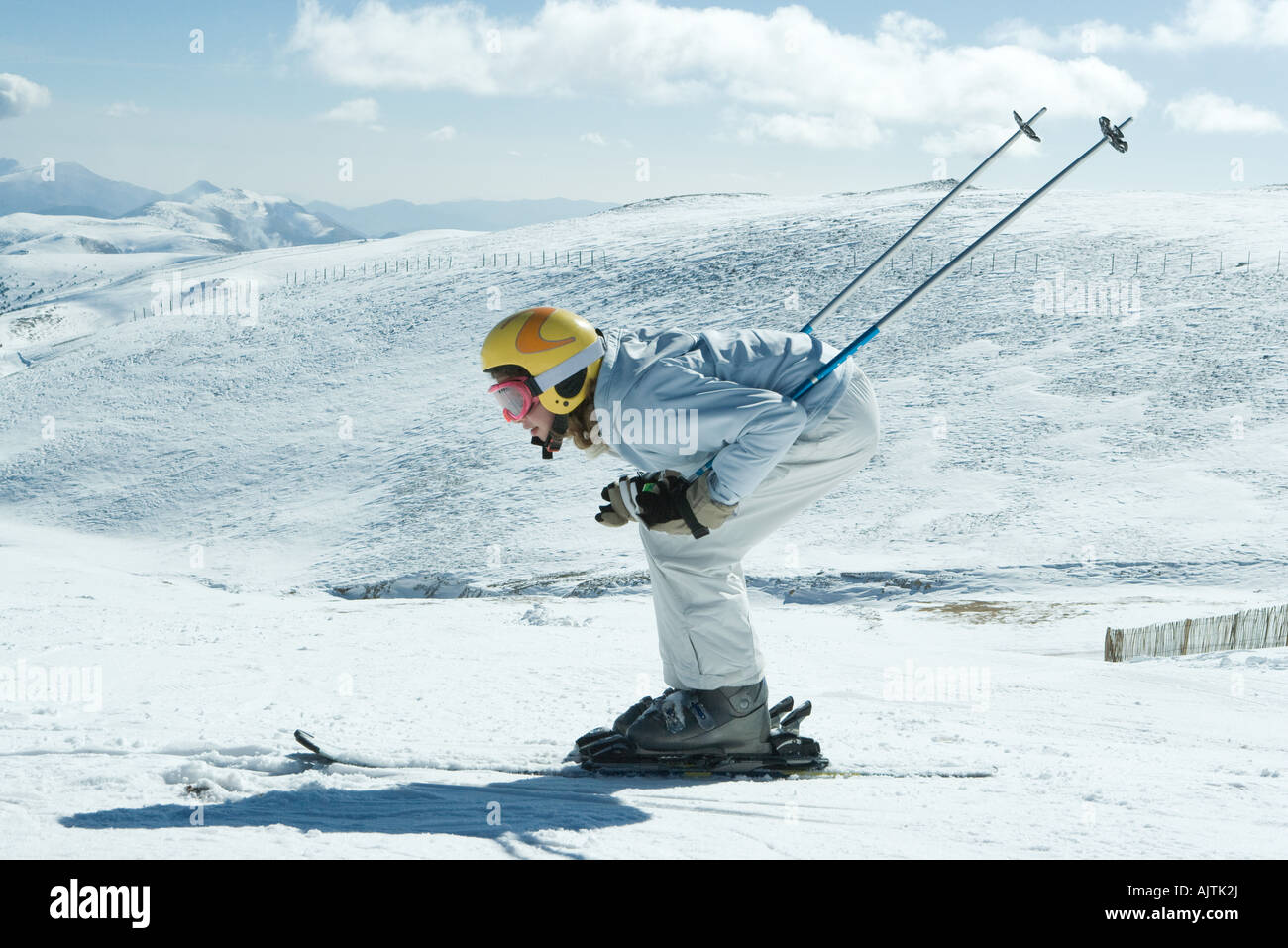 Young skier bending over, side view, full length portrait Stock Photo ...