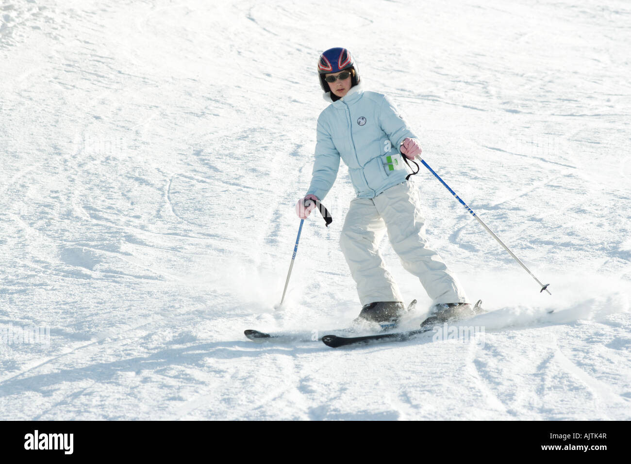 Teenage girl skiing on ski slope, full length Stock Photo - Alamy