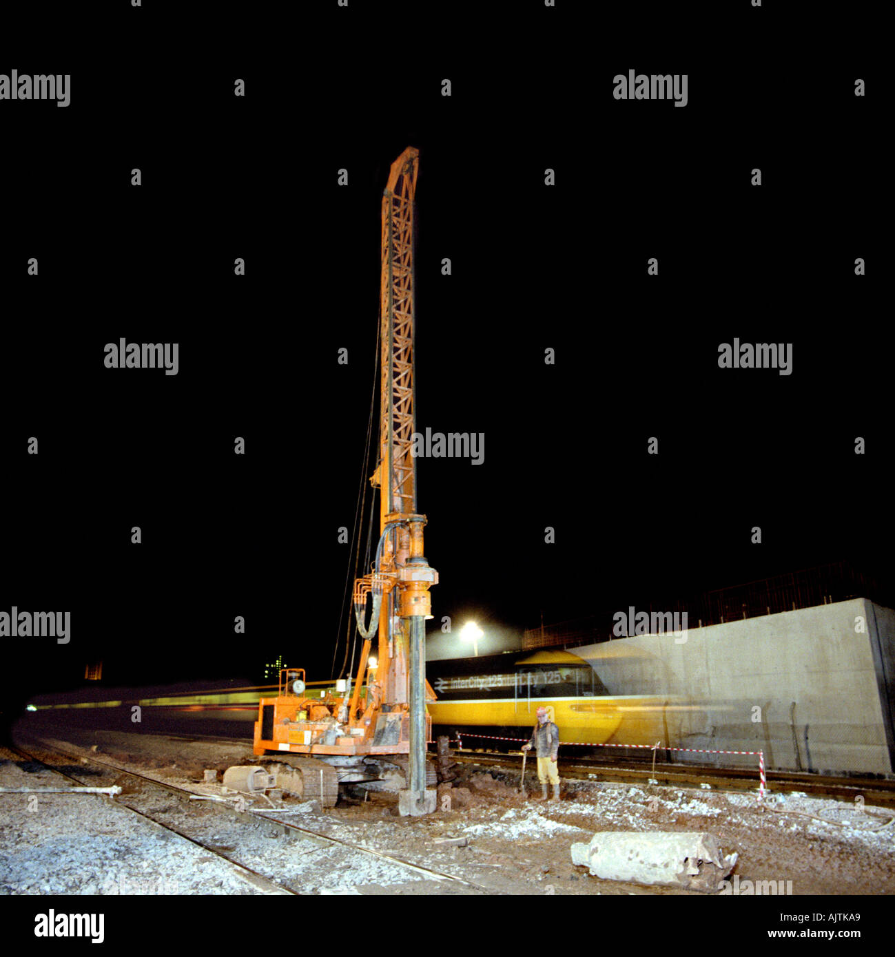 Drilling Rig works at night alongside railway line Stock Photo - Alamy