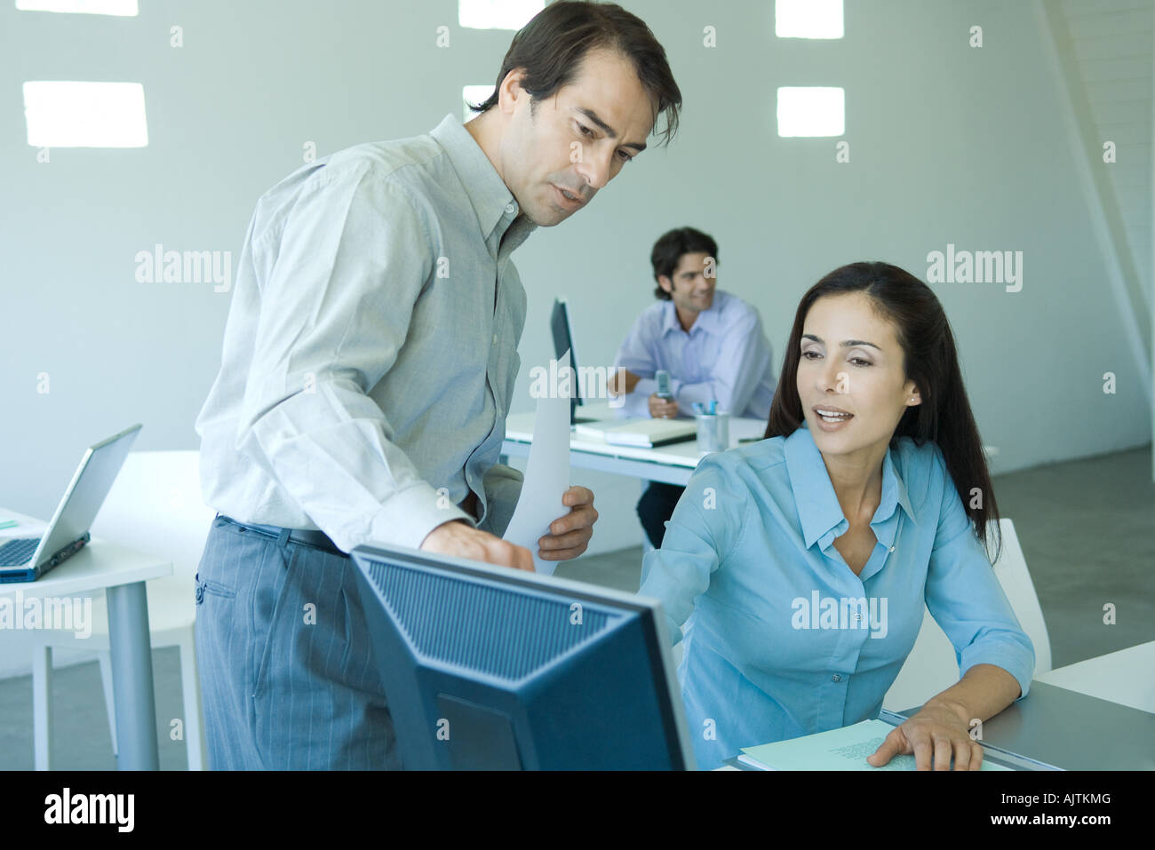 Two business colleagues looking at computer screen together Stock Photo ...