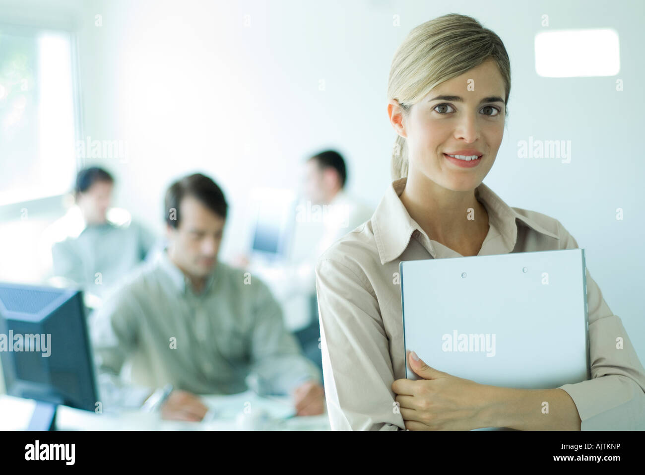 Woman holding laptop to chest hi-res stock photography and images - Alamy