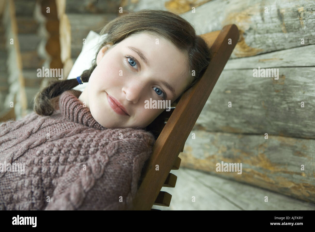 Teen girl leaning back in chair, portrait Stock Photo - Alamy