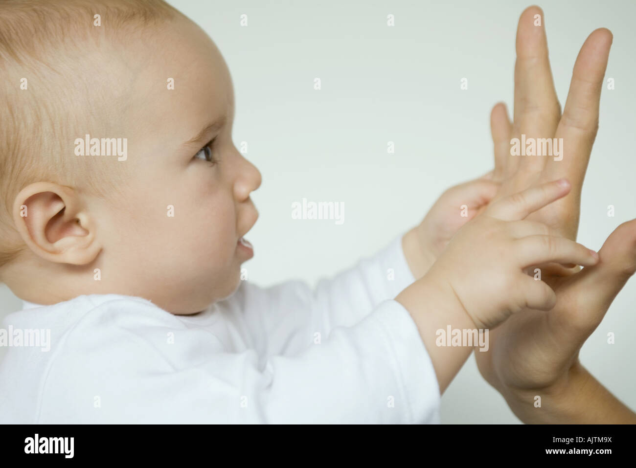 Baby reaching mothers hand profile hi-res stock photography and images ...