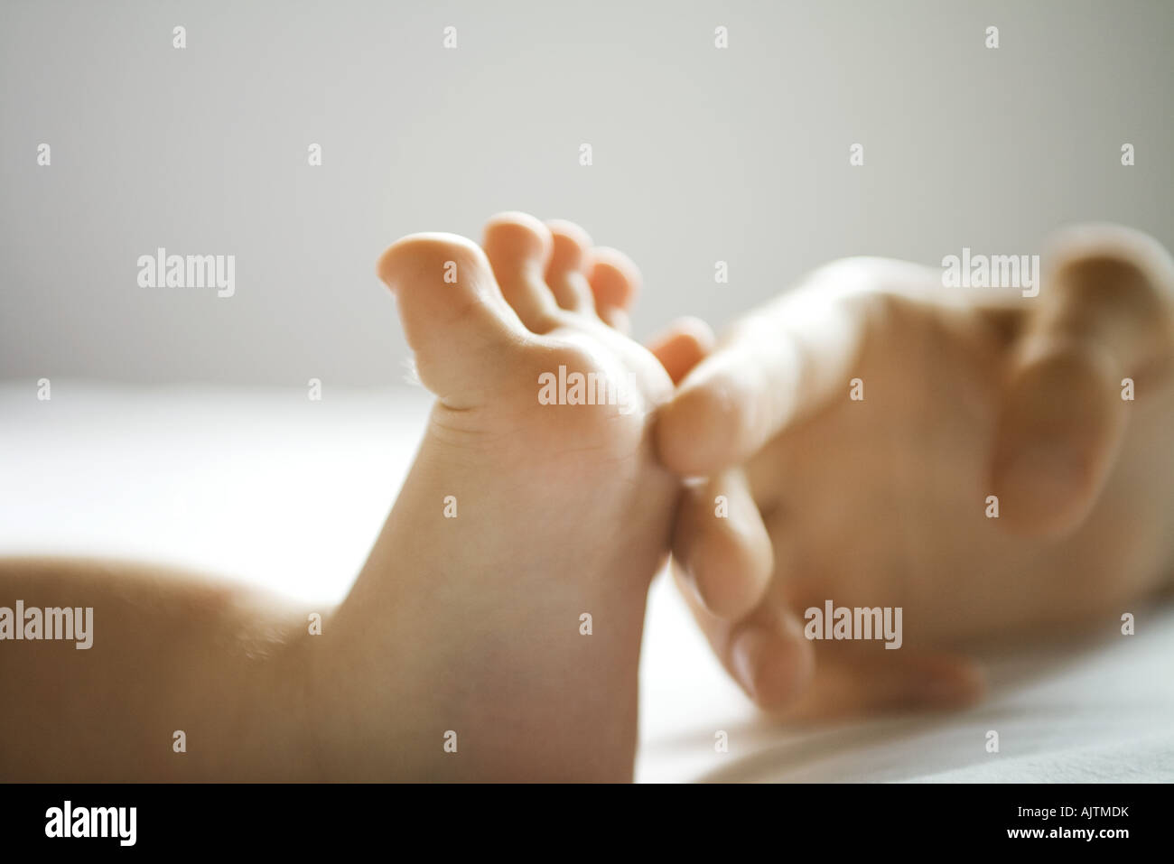 Mother's hand tickling baby's foot, close-up Stock Photo - Alamy