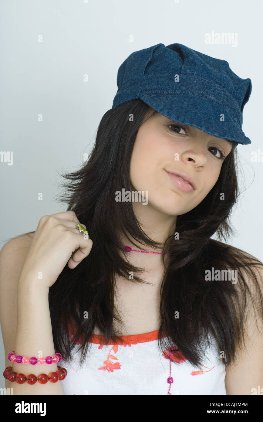 Teenage girl wearing cap, smiling at camera, portrait Stock Photo - Alamy