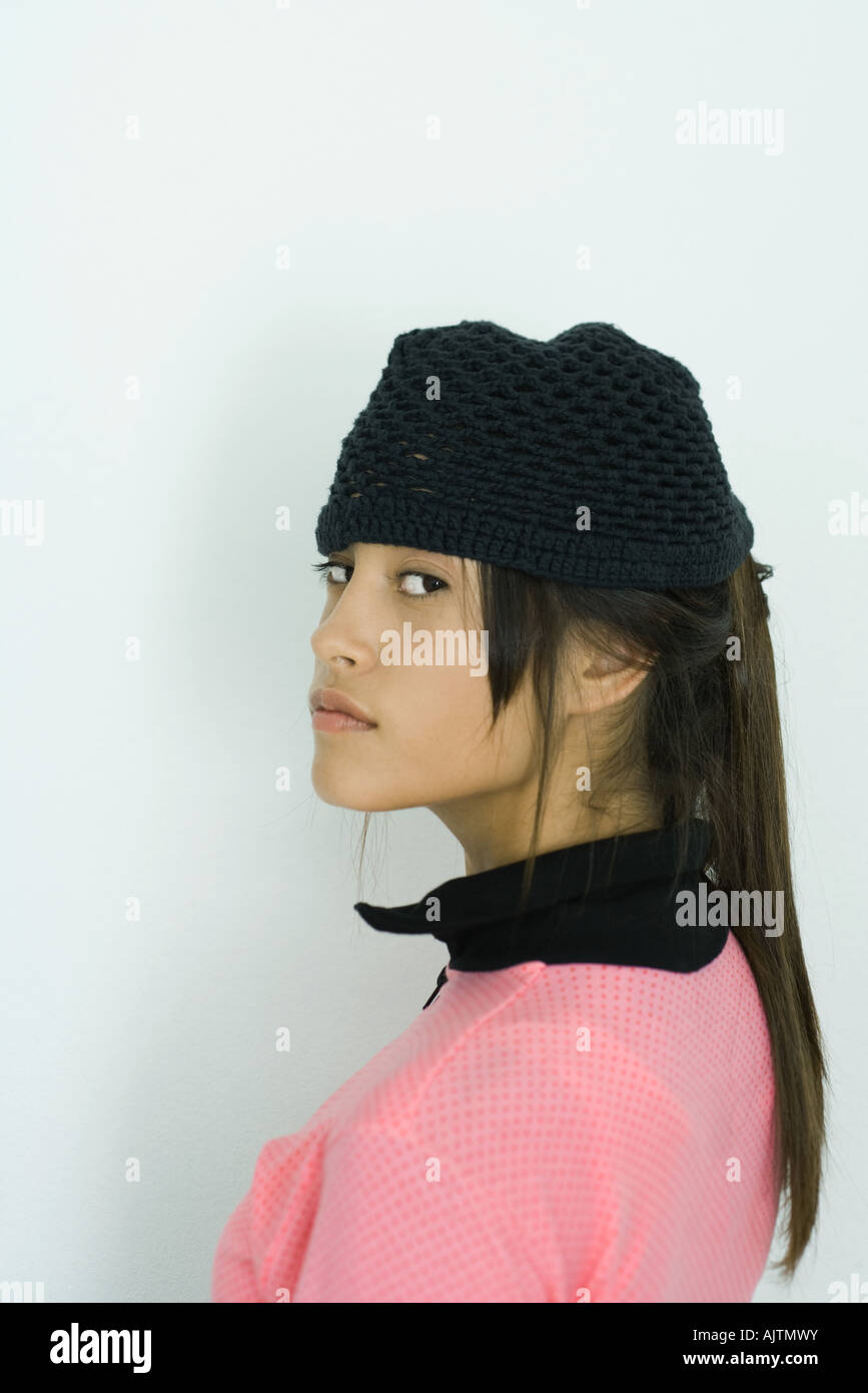 Teenage girl looking over shoulder at camera, portrait Stock Photo - Alamy