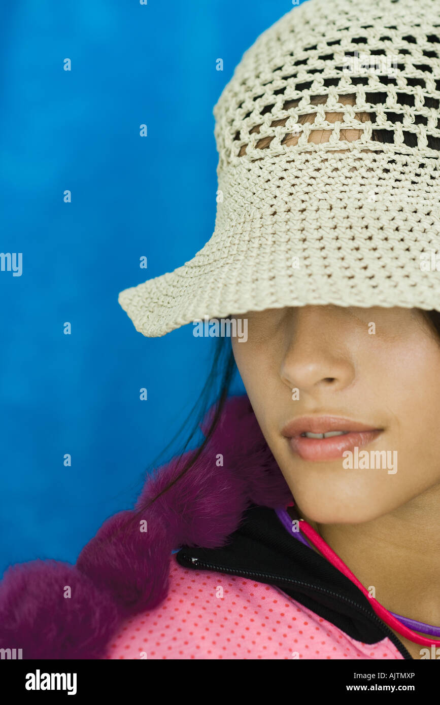 Teenage girl with hat pulled down over eyes, portrait Stock Photo - Alamy