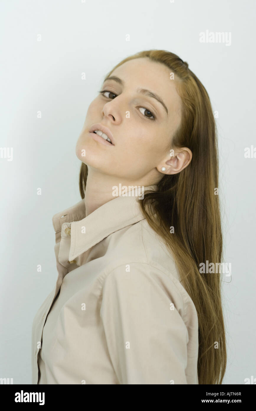 Young woman looking at camera, head back, portrait Stock Photo - Alamy