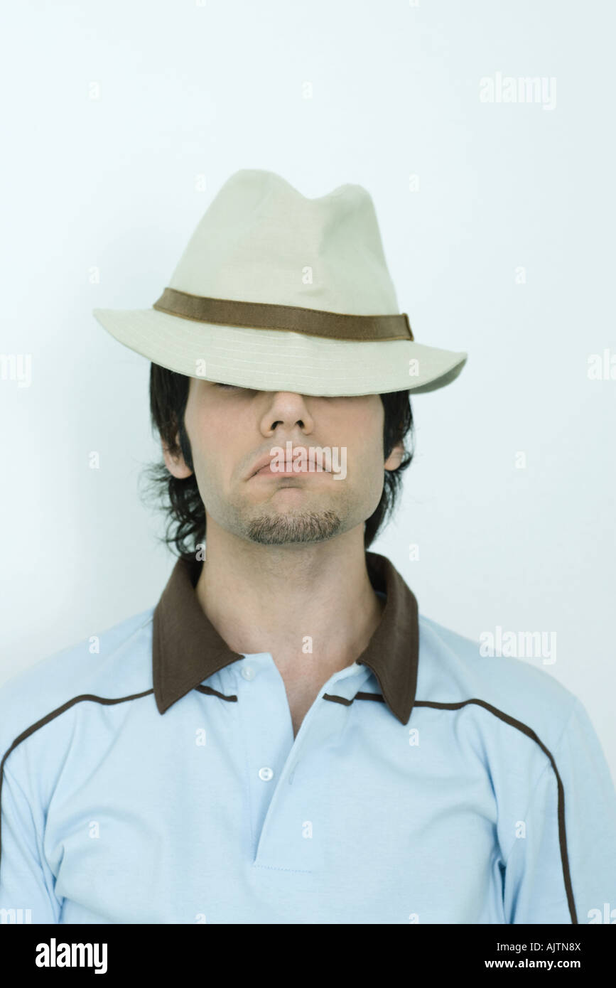 Young man wearing hat, eyes covered, portrait Stock Photo - Alamy