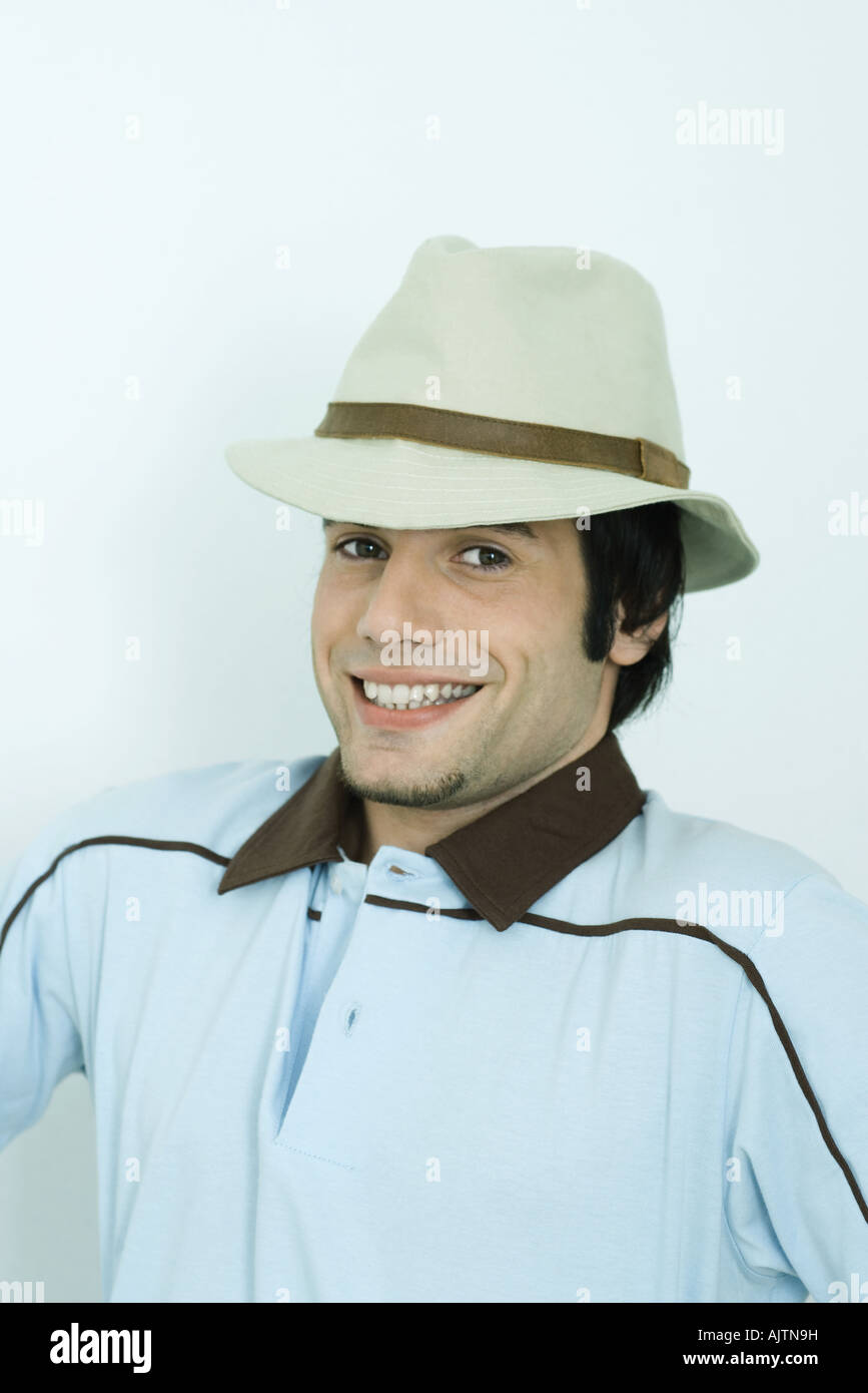 Young man wearing hat, smiling at camera, portrait Stock Photo - Alamy