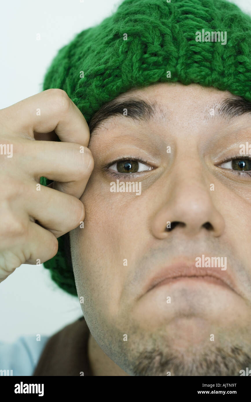 Young man frowning at camera, cropped view, close-up Stock Photo - Alamy