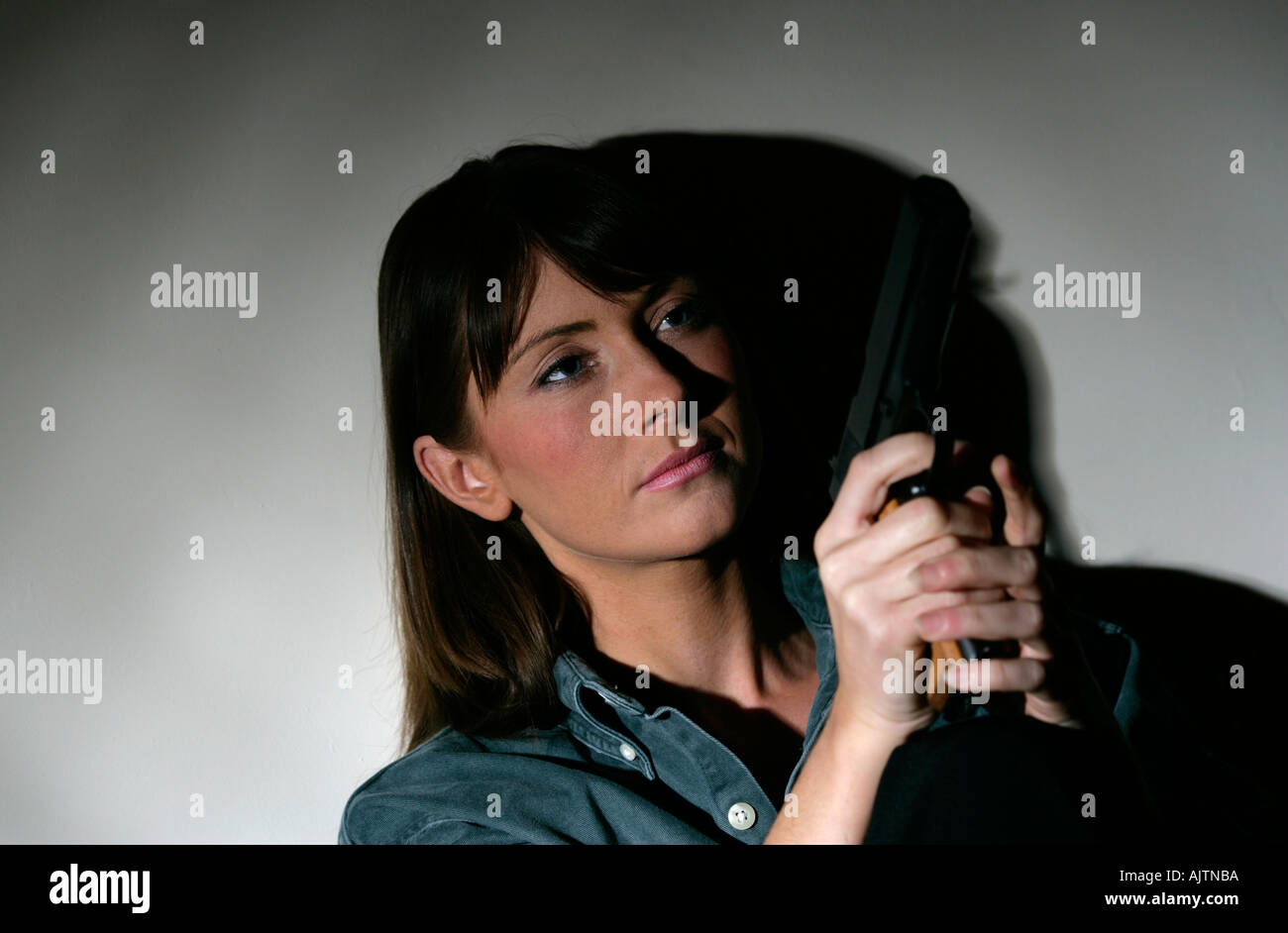 Young woman with a handgun Menace Stock Photo - Alamy
