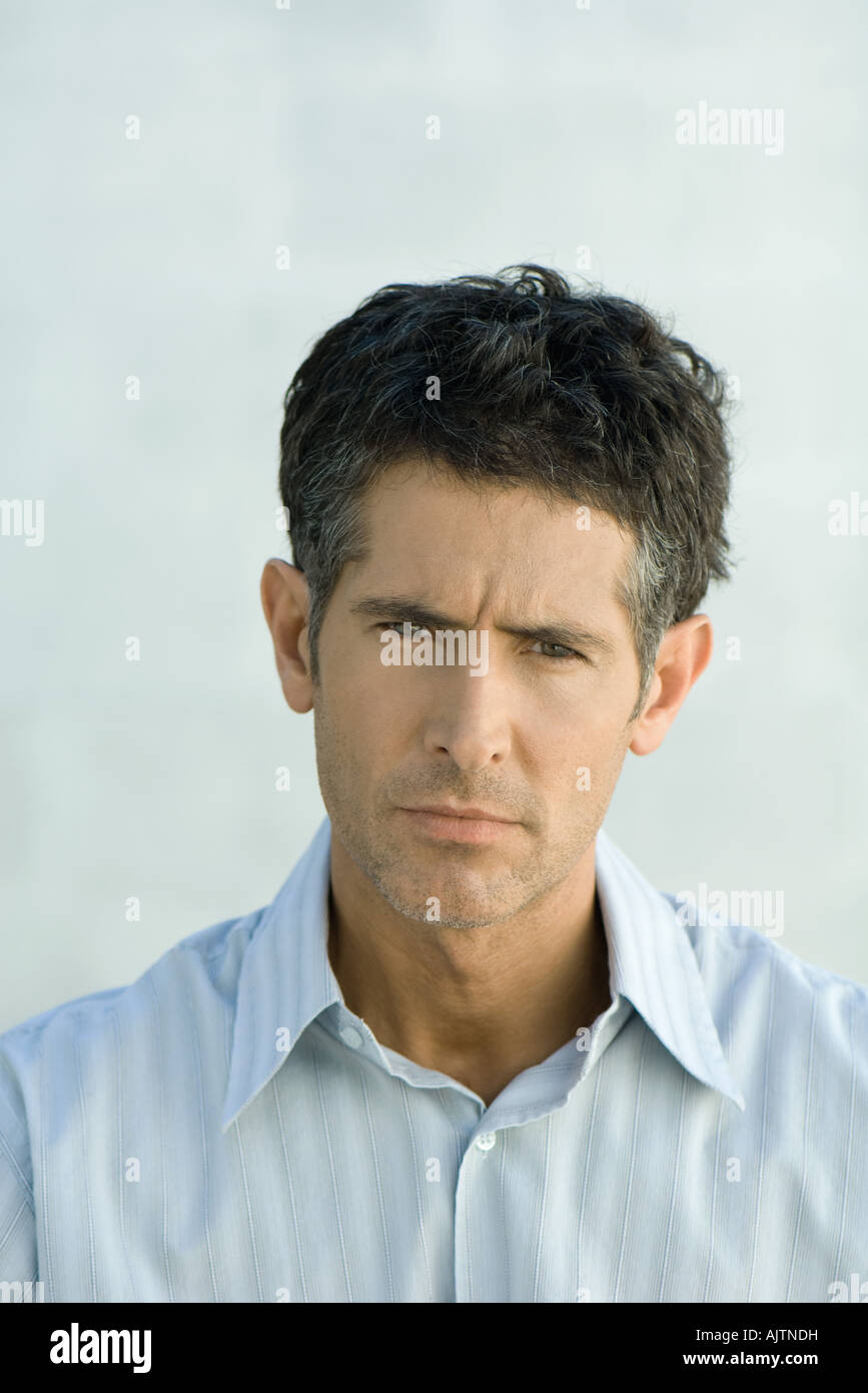 Mature man furrowing brow, looking at camera, portrait Stock Photo - Alamy