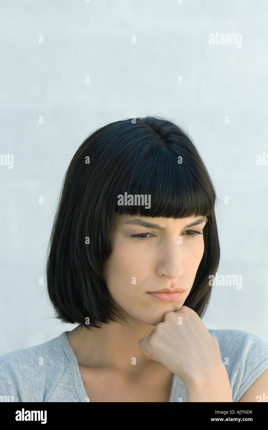 Young woman hand under chin, looking away, portrait Stock Photo - Alamy