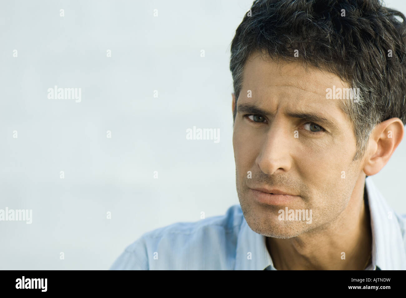 Man furrowing brow, portrait Stock Photo - Alamy