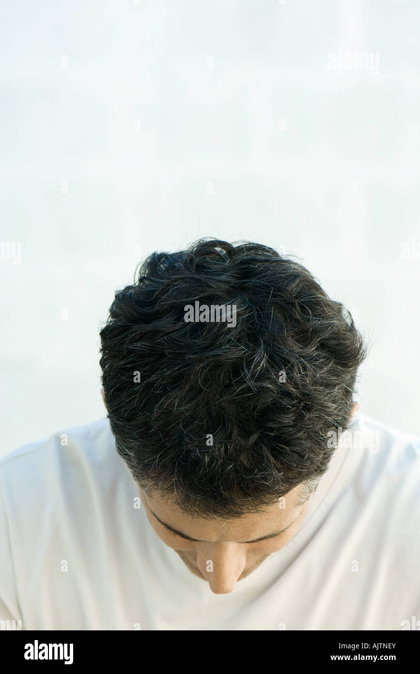 Mature man with head down, close-up Stock Photo - Alamy