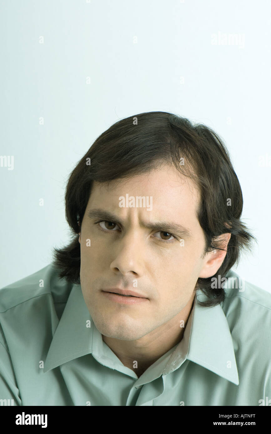 Man scowling at camera, portrait Stock Photo - Alamy