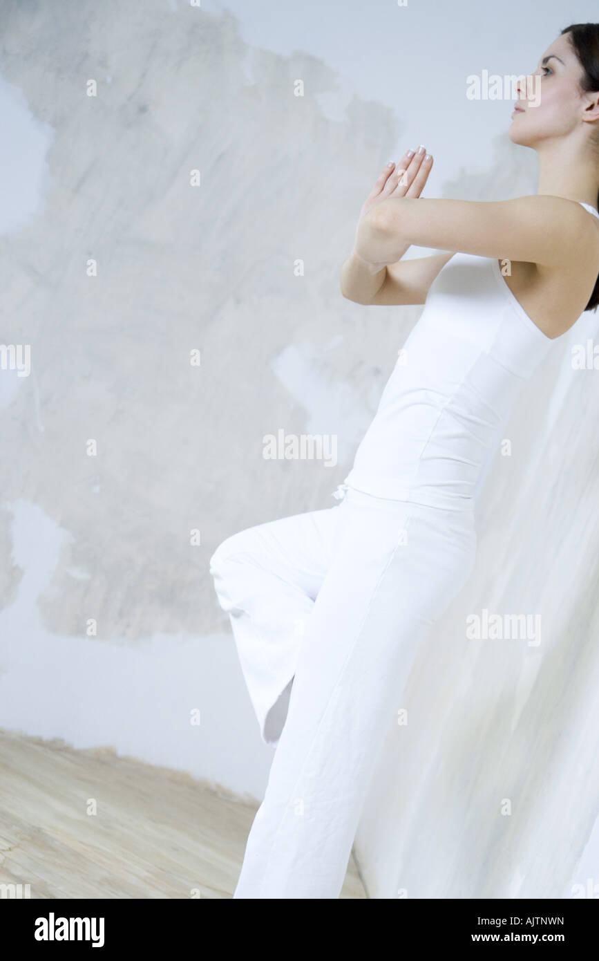 Woman standing in tree pose, side view Stock Photo - Alamy