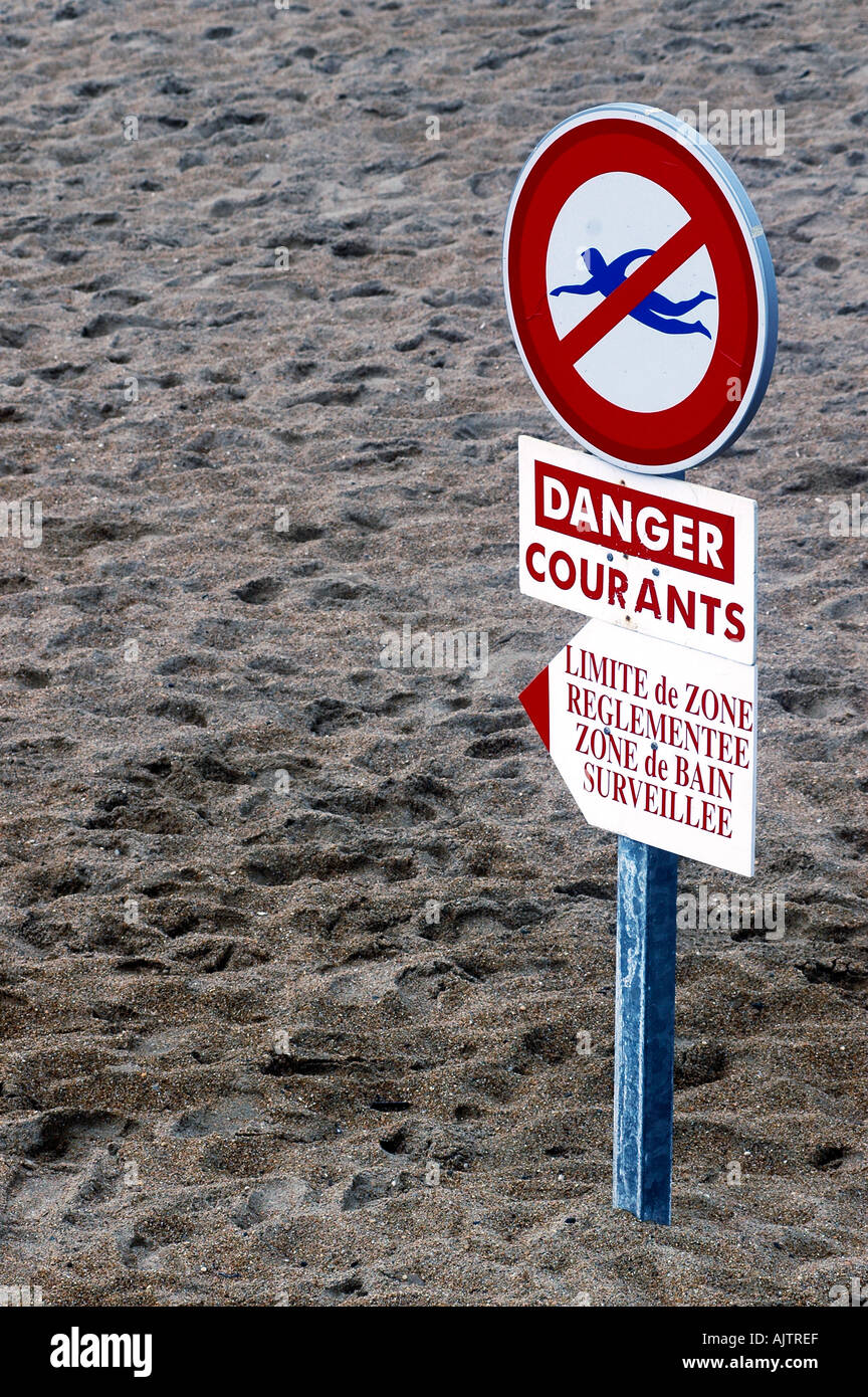 Danger sign warning of strong currents on public beach les cavalier ...