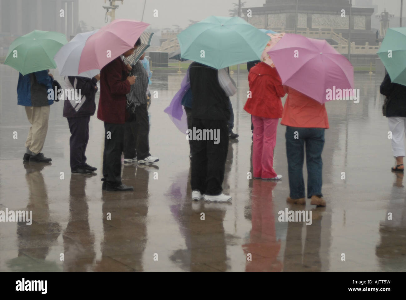 Chinese tourists in the rain in Tiananmen Square, Beijing Stock Photo ...