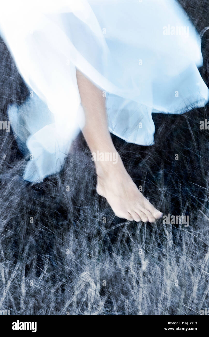 ghostly woman running on the grass Stock Photo - Alamy