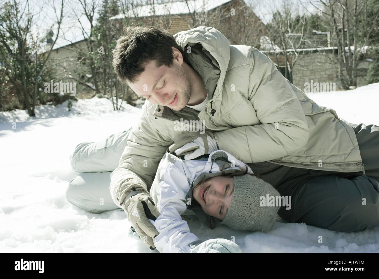 Two friends roughhousing outdoors in snow Stock Photo - Alamy