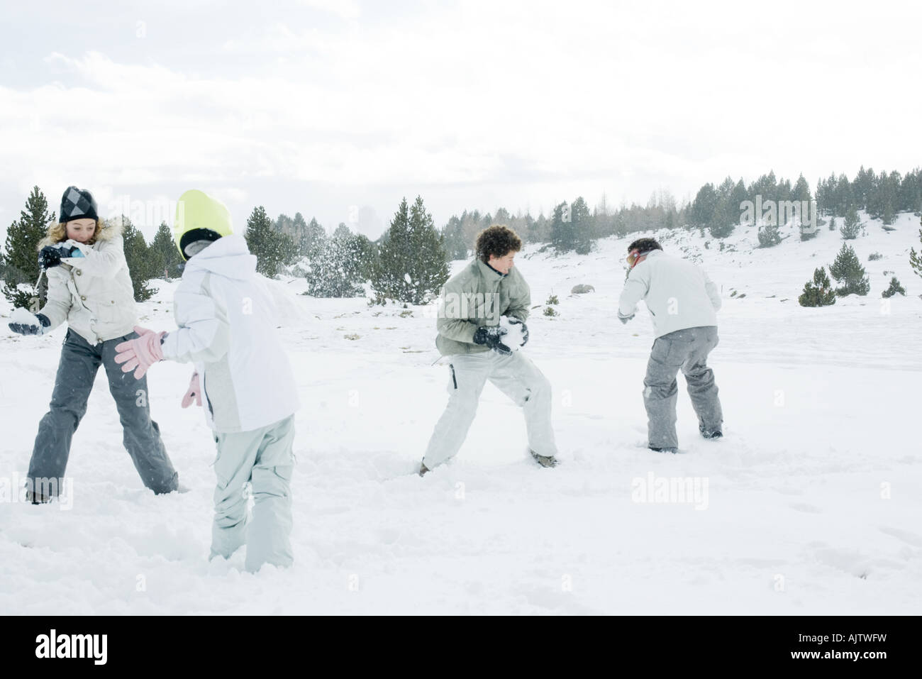 Young friends having snowball fight Stock Photo - Alamy