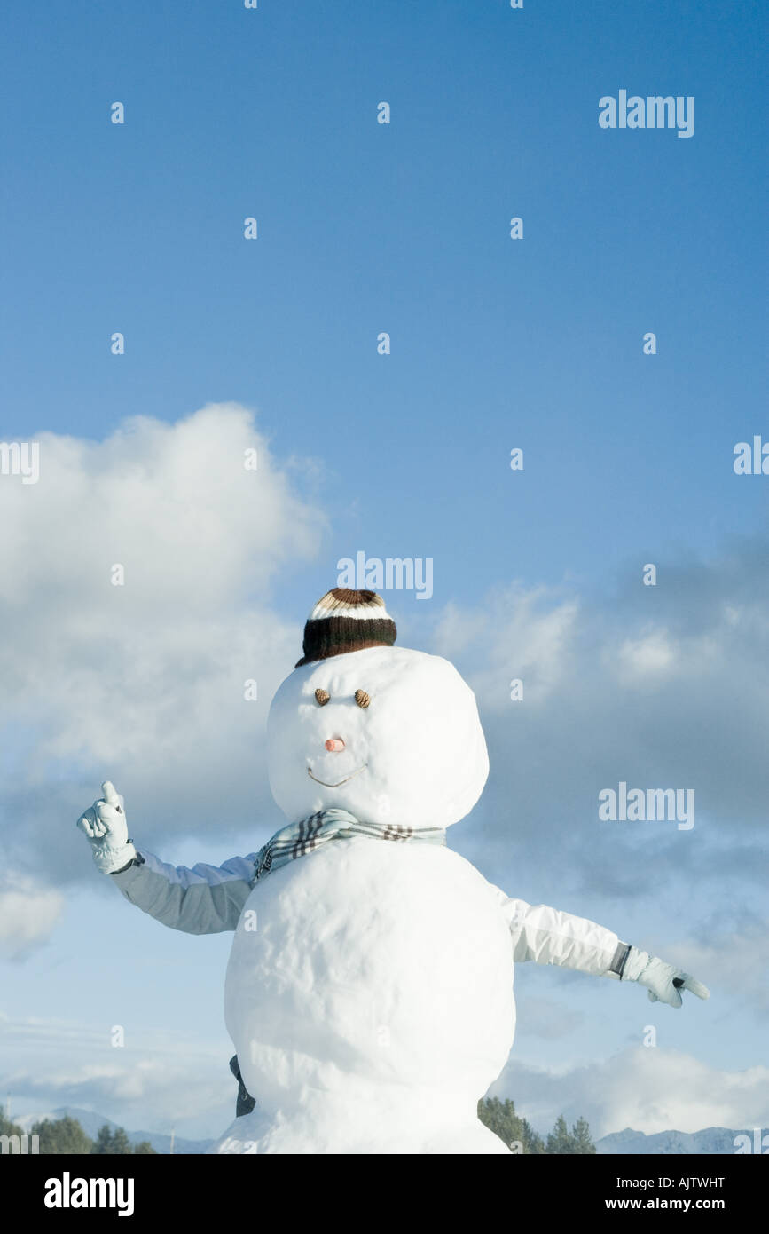 Person sticking arms out from behind snowman Stock Photo - Alamy