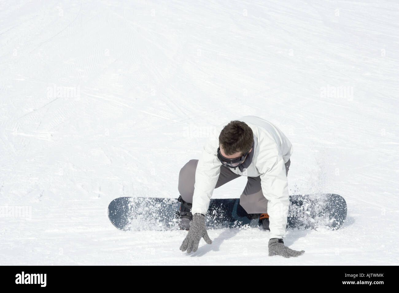 Young man on snowboard falling over, full length Stock Photo - Alamy