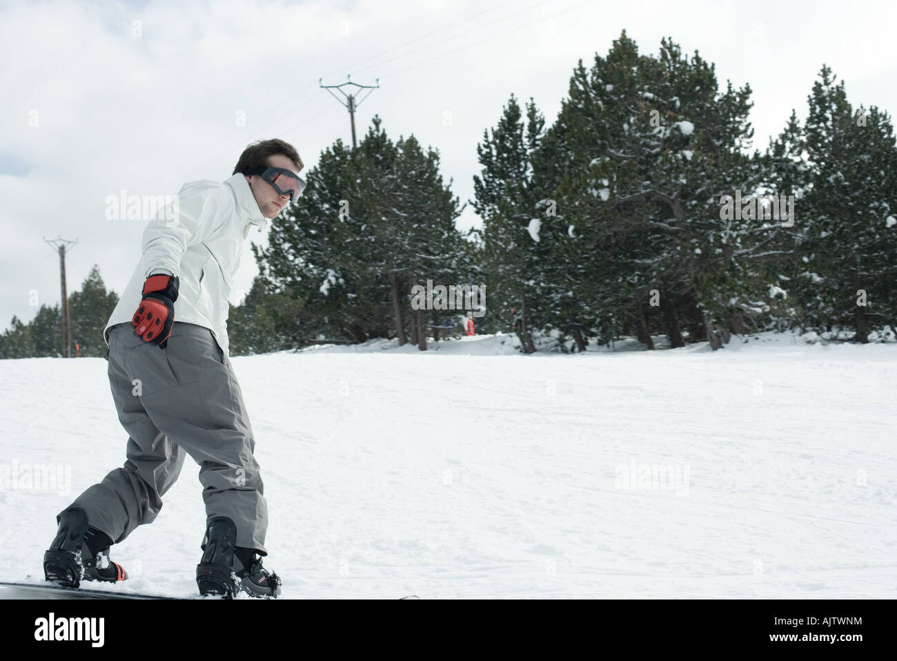 Young man snowboarding, full length Stock Photo - Alamy