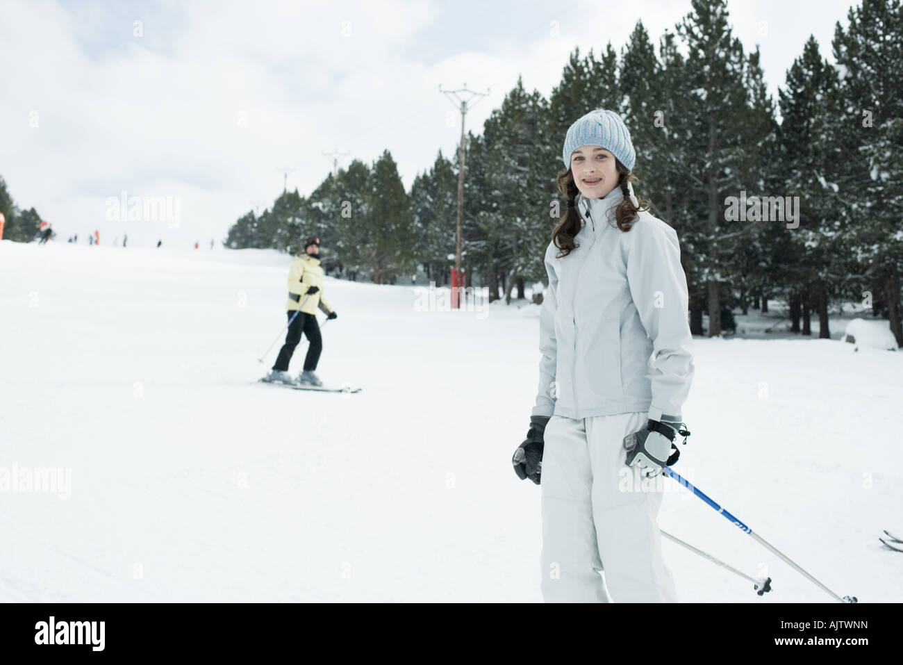 Teenage girl on skis, smiling at camera Stock Photo - Alamy