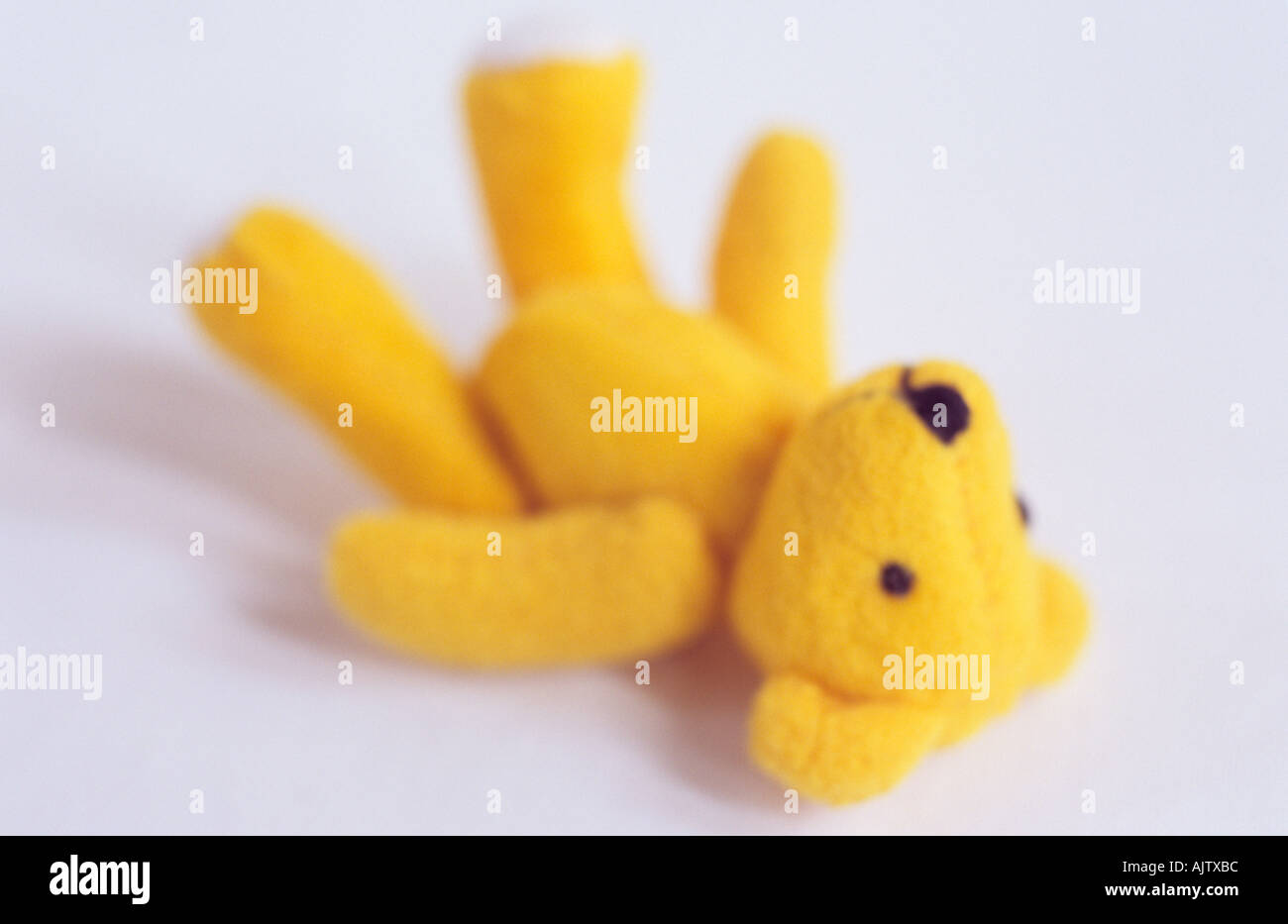 Shallow focus teddy bear lying on a plain white background Stock Photo ...