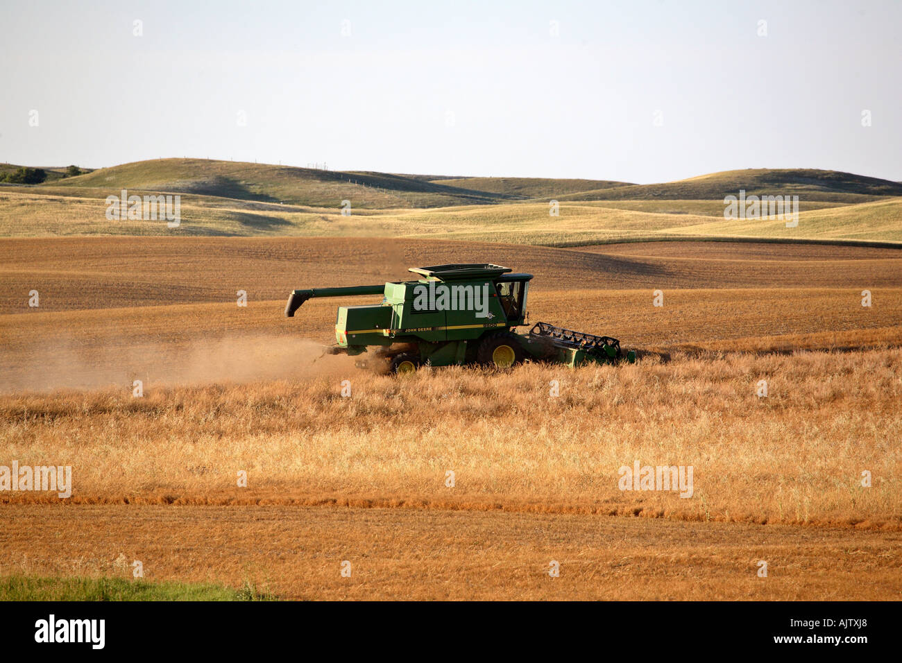 Farmer combing a grain crop in scenic Saskatchewan Canada Stock Photo ...
