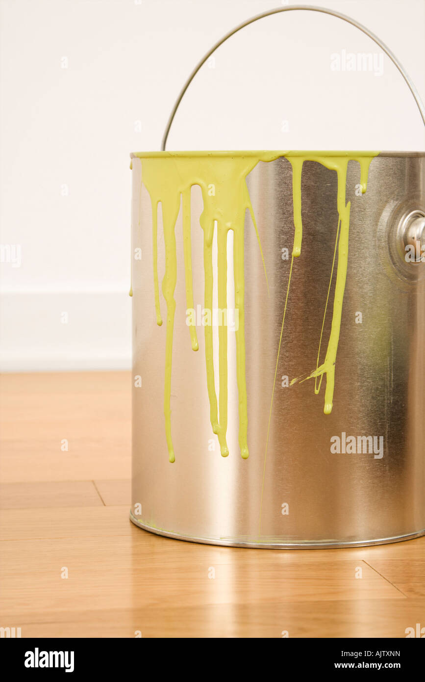 Paint can with drips sitting on wood floor Stock Photo - Alamy