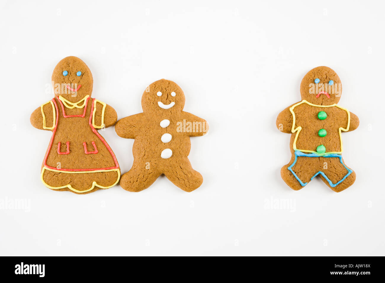 Frowning male gingerbread cookie standing separate from happy ...