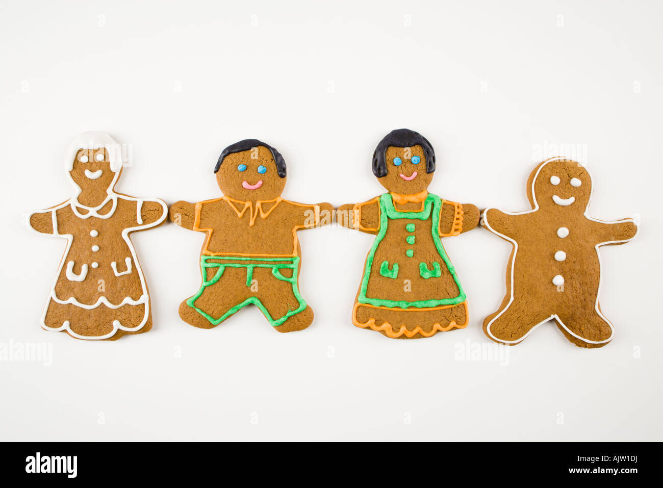 Four male and female gingerbread cookies holding hands Stock Photo - Alamy