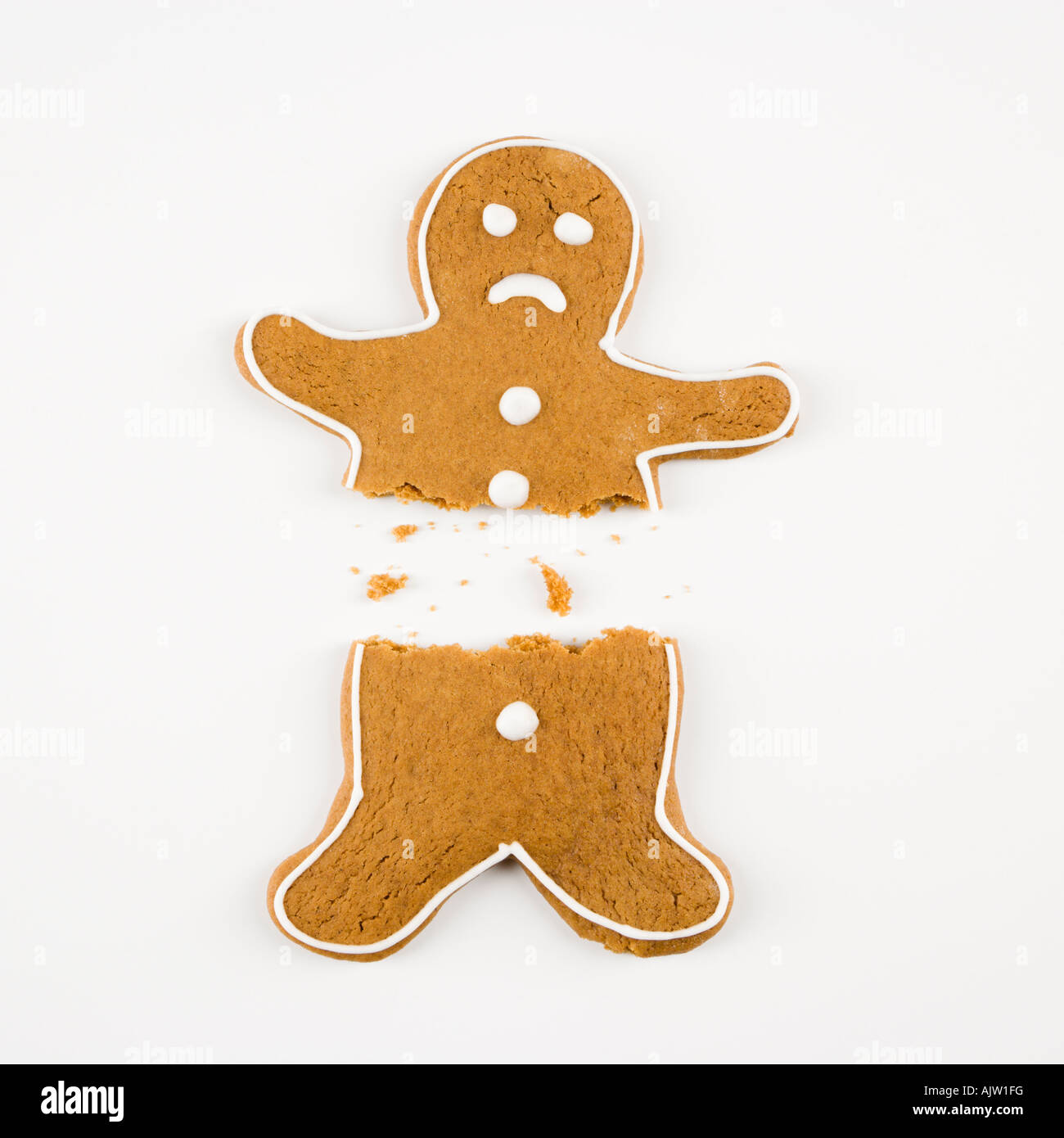 Frowning male gingerbread cookie broken in half Stock Photo - Alamy