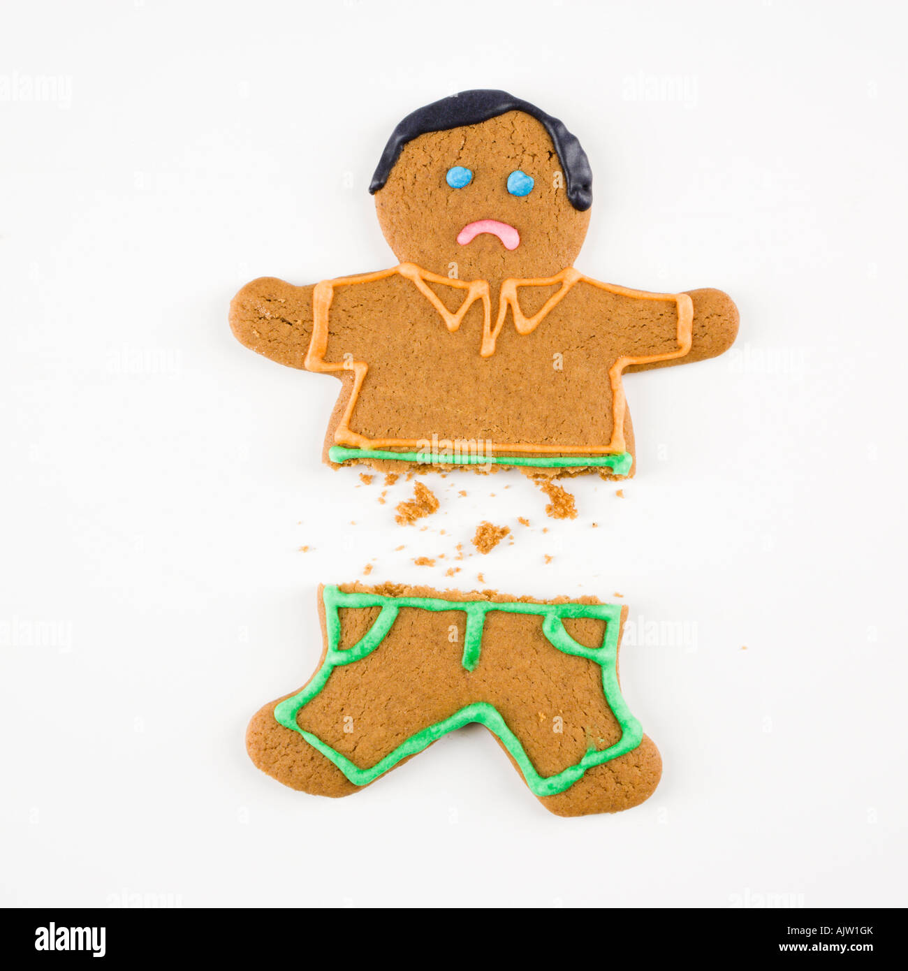 Frowning male gingerbread cookie broken in half Stock Photo - Alamy