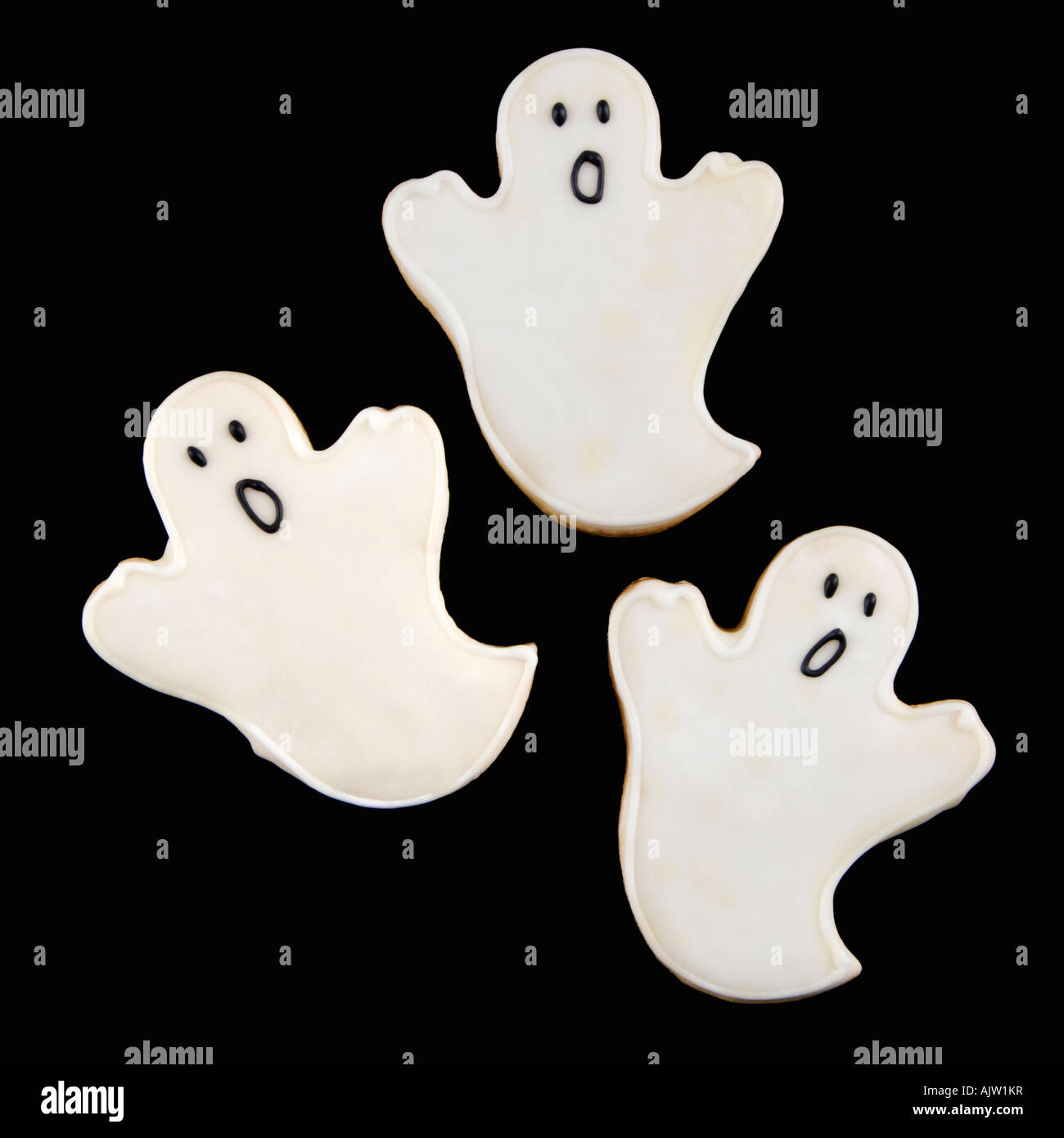 Three sugar cookies in shape of ghosts with decorative icing Stock ...