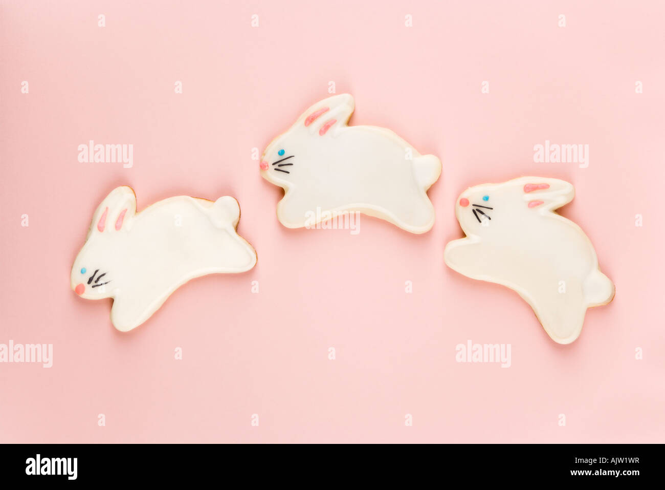 Three bunny shaped sugar cookies with decorative icing Stock Photo - Alamy